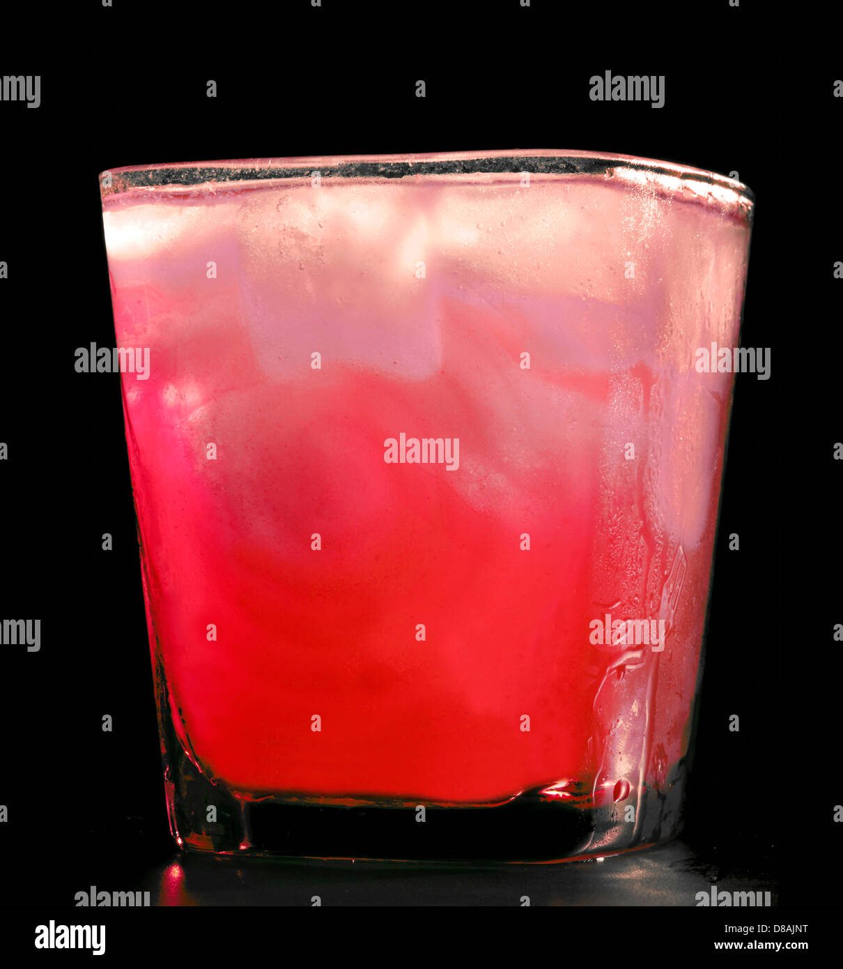 Cold red cocktail on black background Stock Photo - Alamy