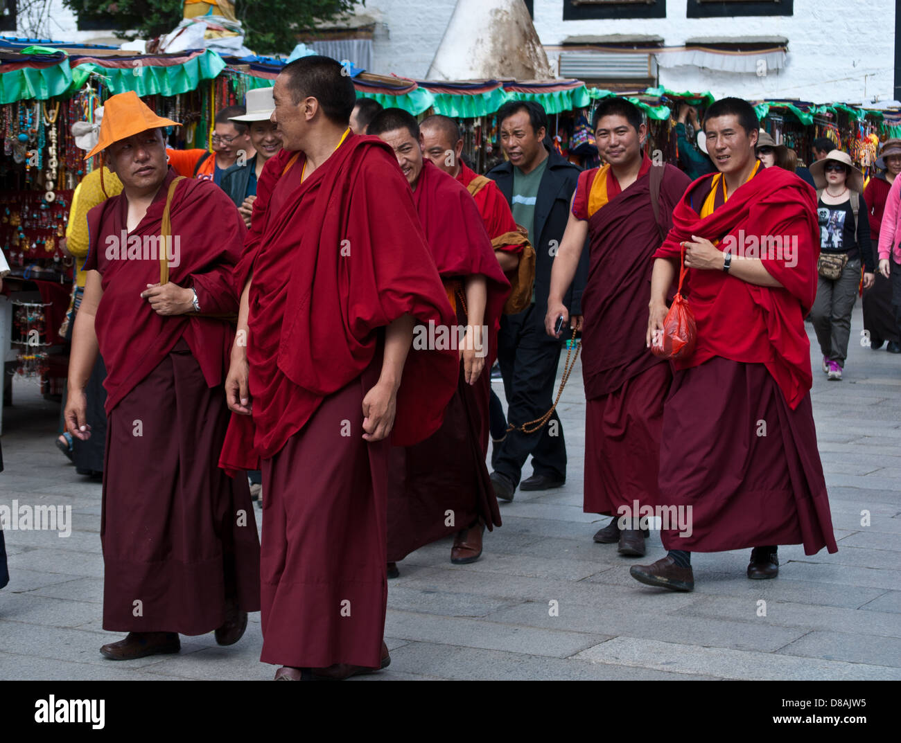 Buddhist monks walking on Barkhor street around Jokhang monastery, old ...