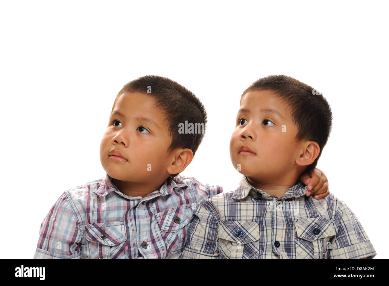 Asian twin brothers looking up and away Stock Photo - Alamy