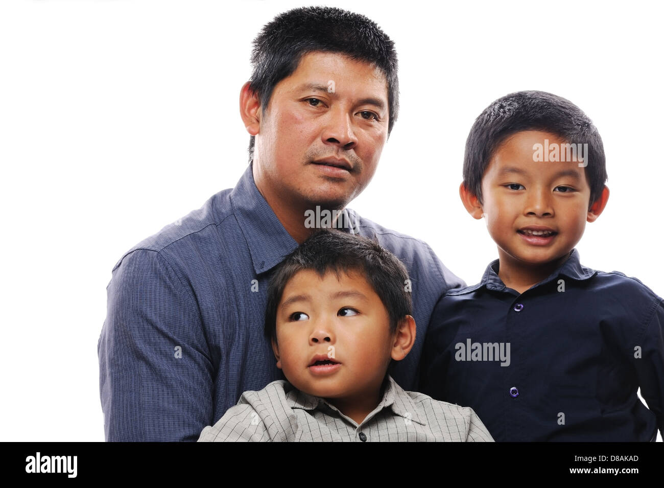 Asian father hugs his two sons in front of isolated background Stock ...