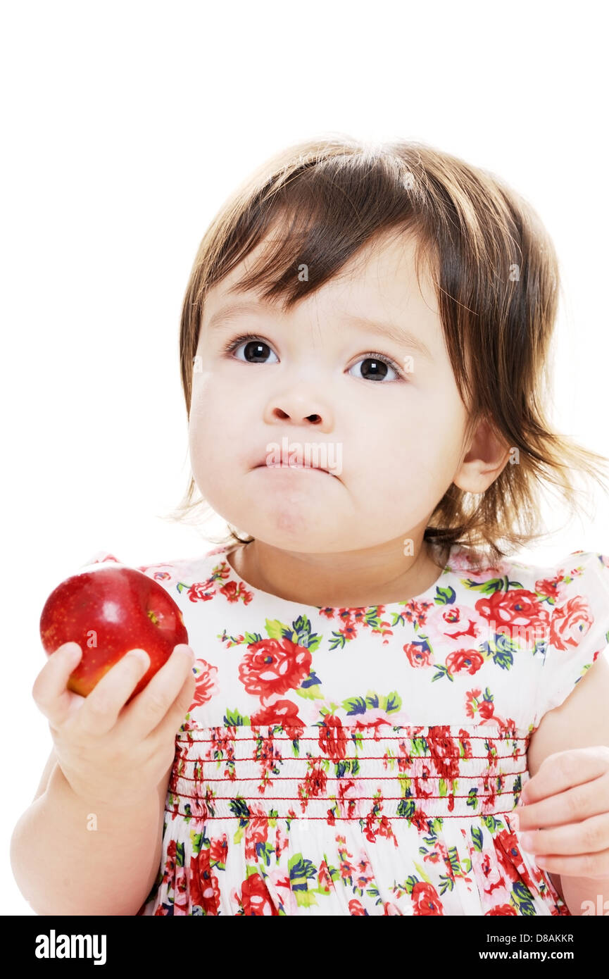 Baby girl tasting a red fresh red apple Stock Photo - Alamy