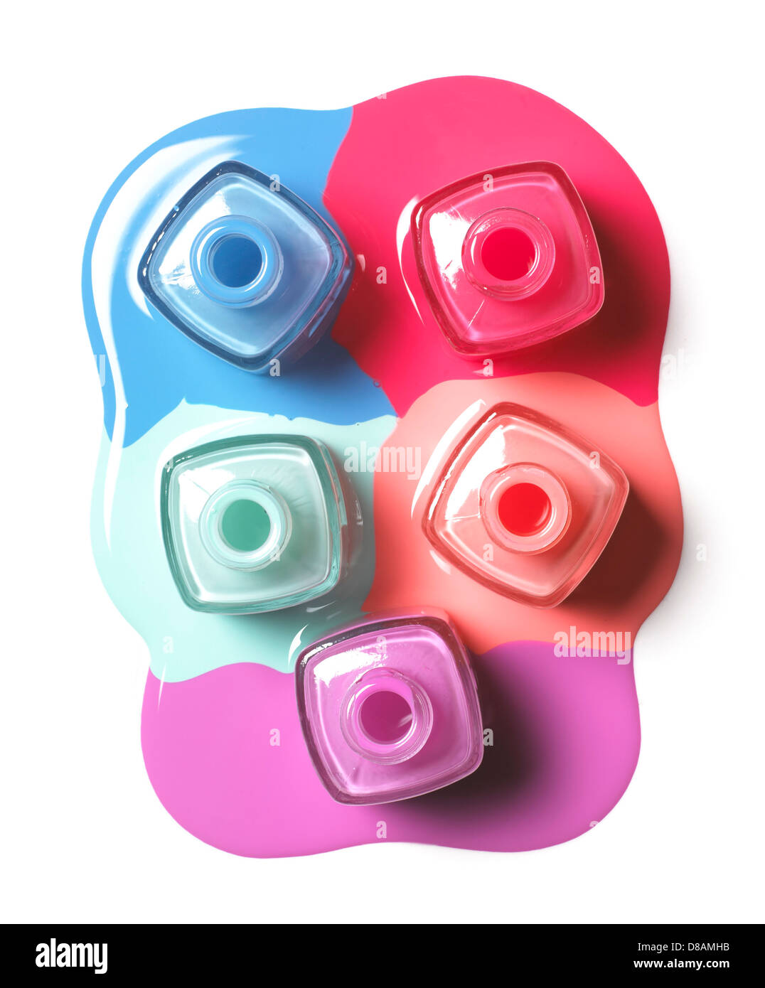 coloured nail polish pots in puddle cut out onto white background Stock ...