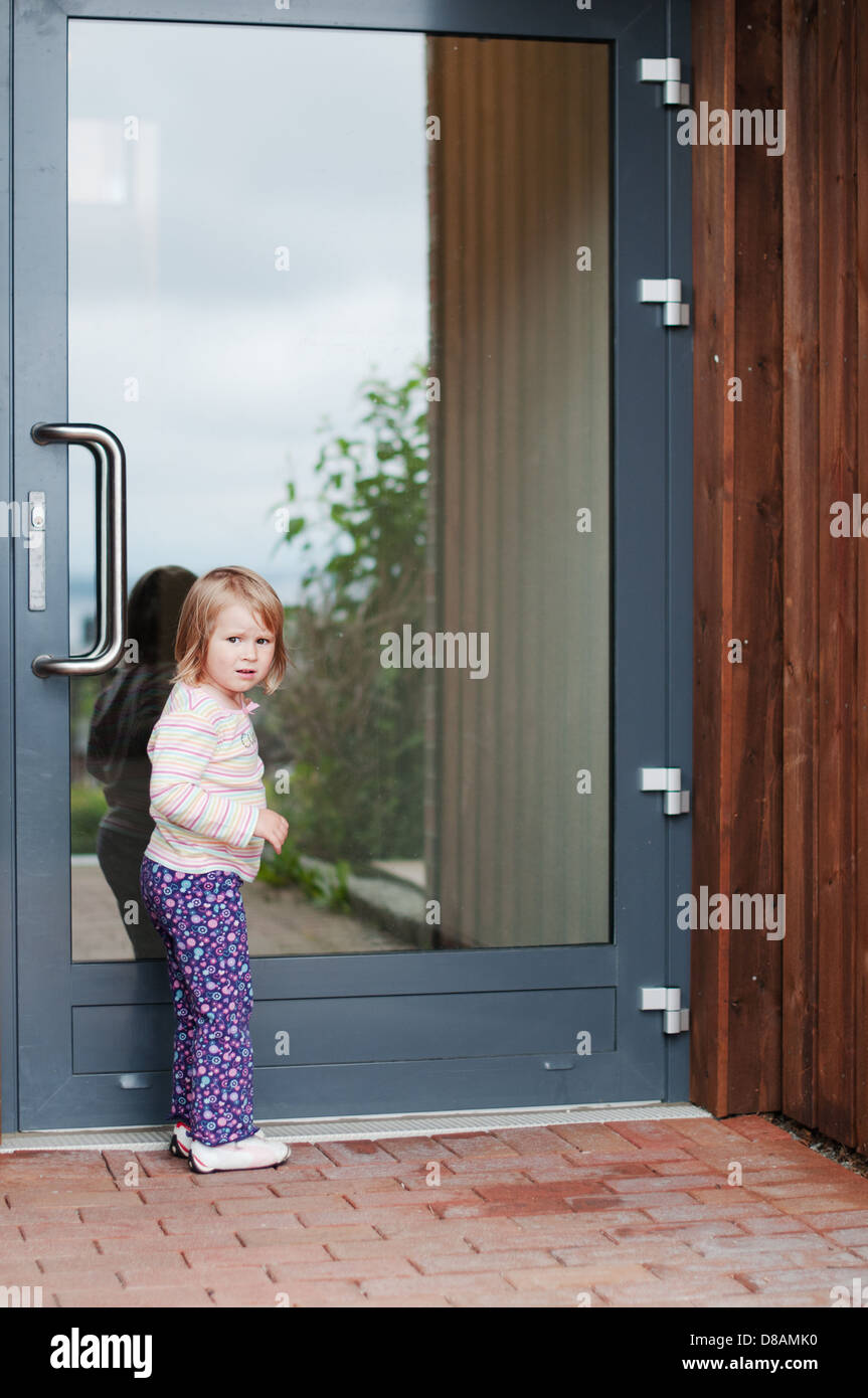 The outdoor photo of the little girl waiting for someone in front of ...
