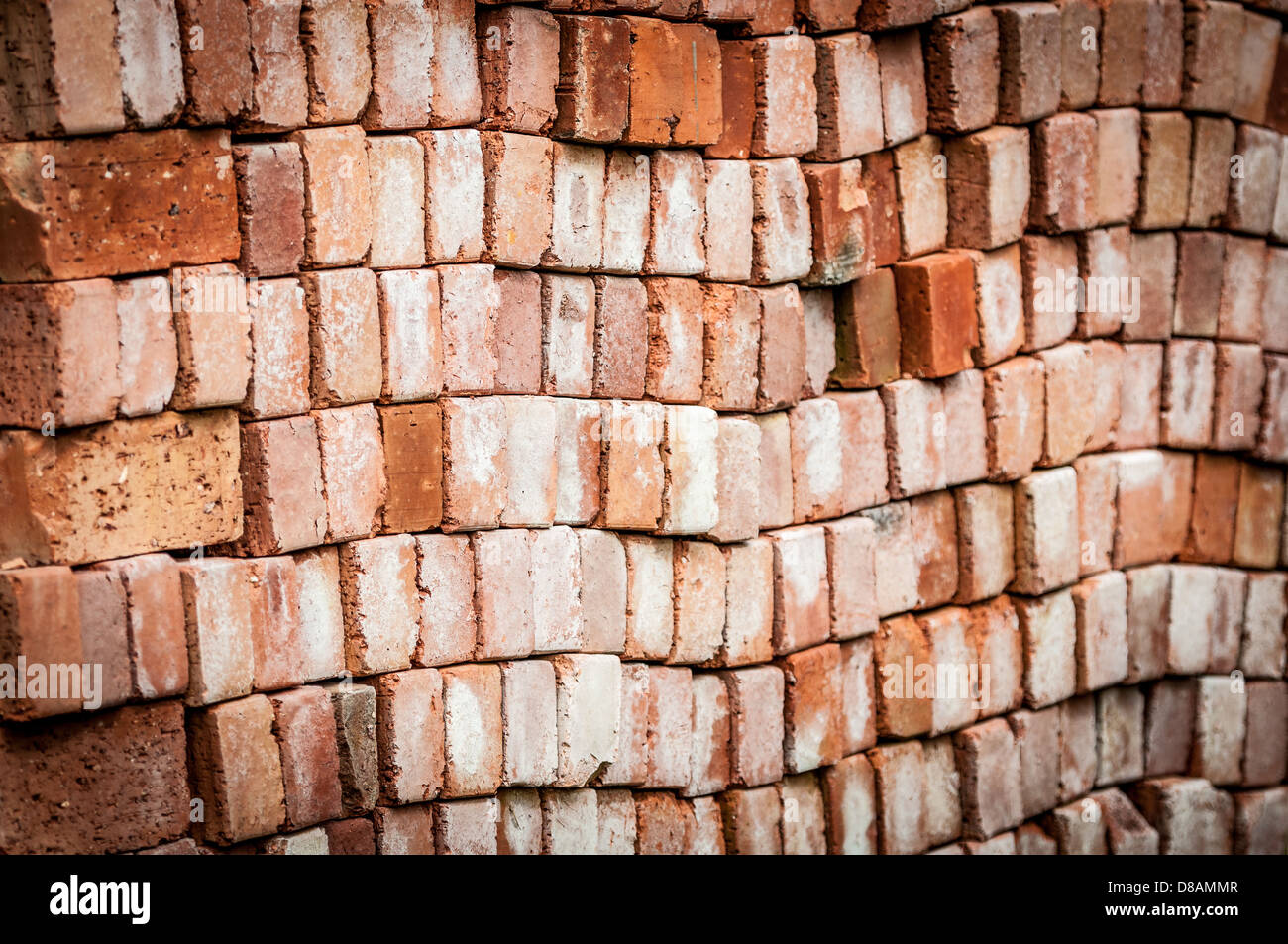 New red brick pavers stacked in rows like wall. Store of bricks ready ...