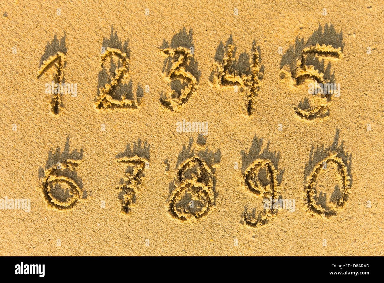 Numbers (from one to ten) written on a sandy beach Stock Photo - Alamy