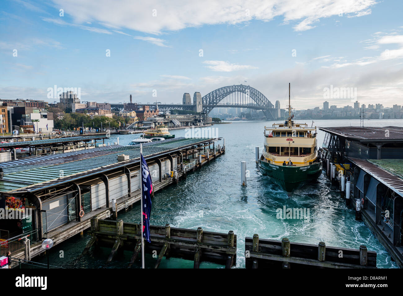 Ferries at Circular Quay terminal with the Sydney Harbour Bridge in the ...