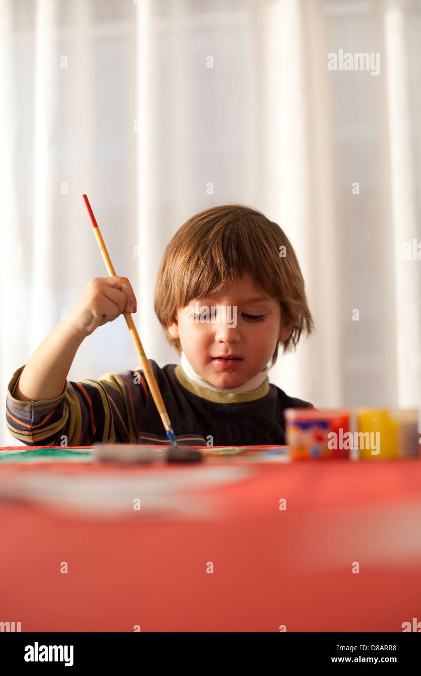 Child painting with a brush Stock Photo - Alamy