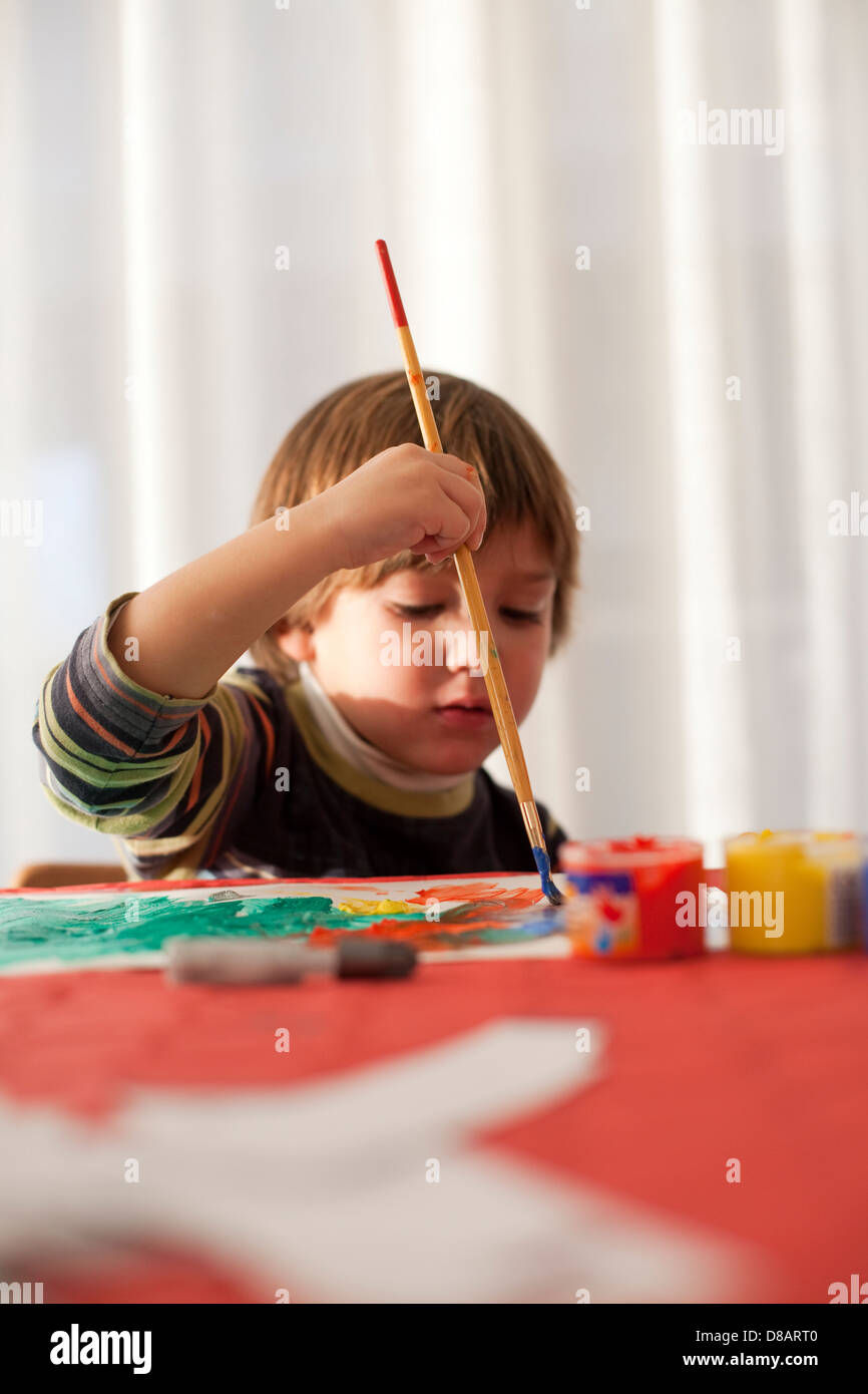 Child painting with a brush Stock Photo - Alamy