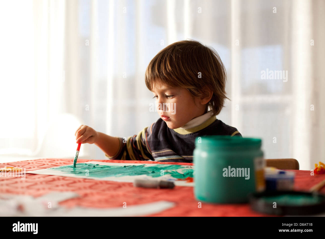 Child painting with a brush Stock Photo - Alamy