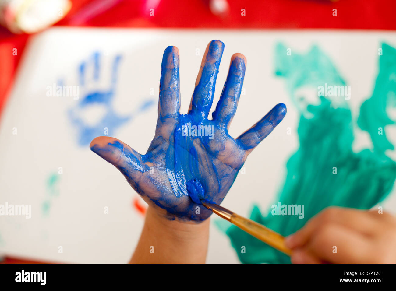 Hand with blue paint hi-res stock photography and images - Alamy