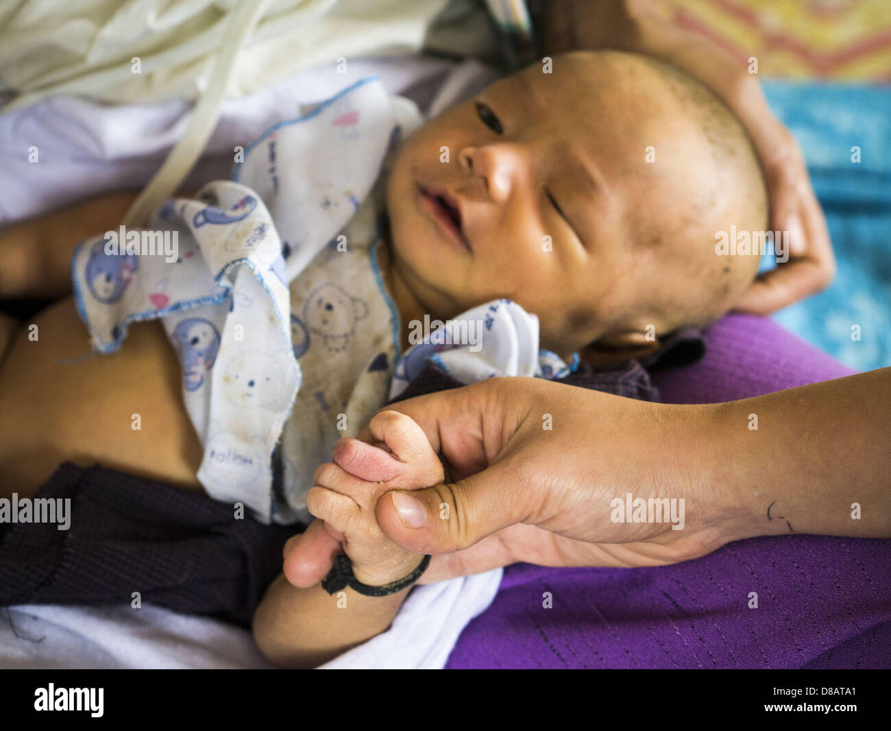 May 21, 2013 - Mae Ku, Tak, Thailand - A medic takes the pulse of a ...