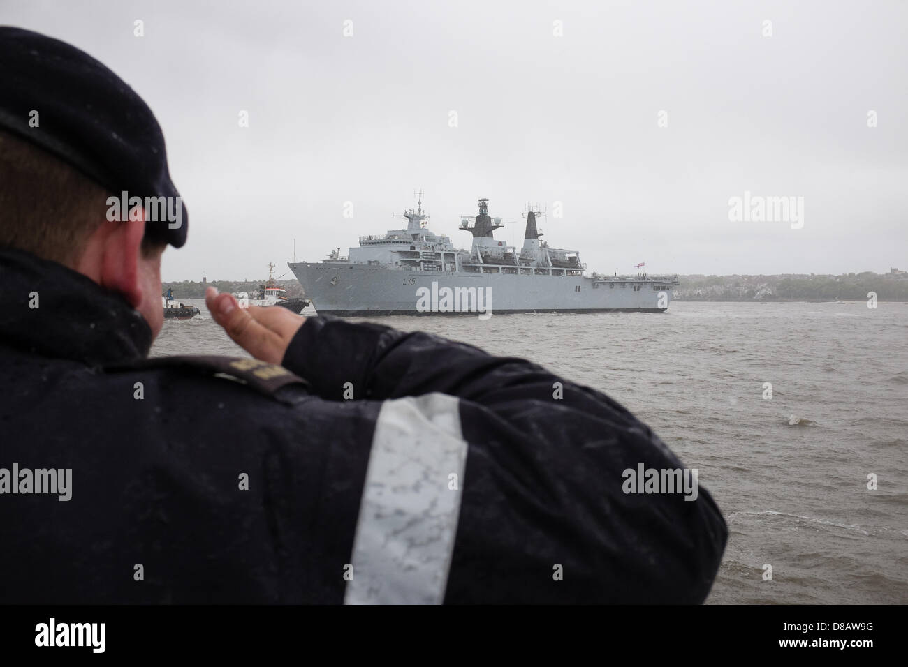 Liverpool, UK. 23rd May 2013. A member of the Royal Navy salutes HMS ...