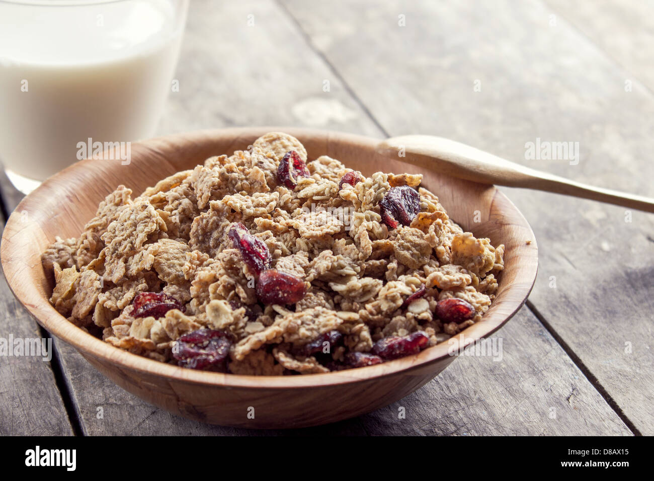 A bowl of cereal with cranberries on the table Stock Photo - Alamy
