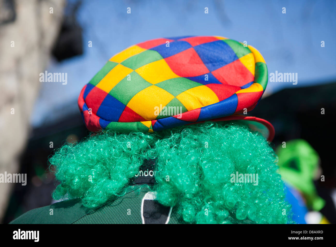 Irish rugby fan with a green wig and checked hat Stock Photo - Alamy