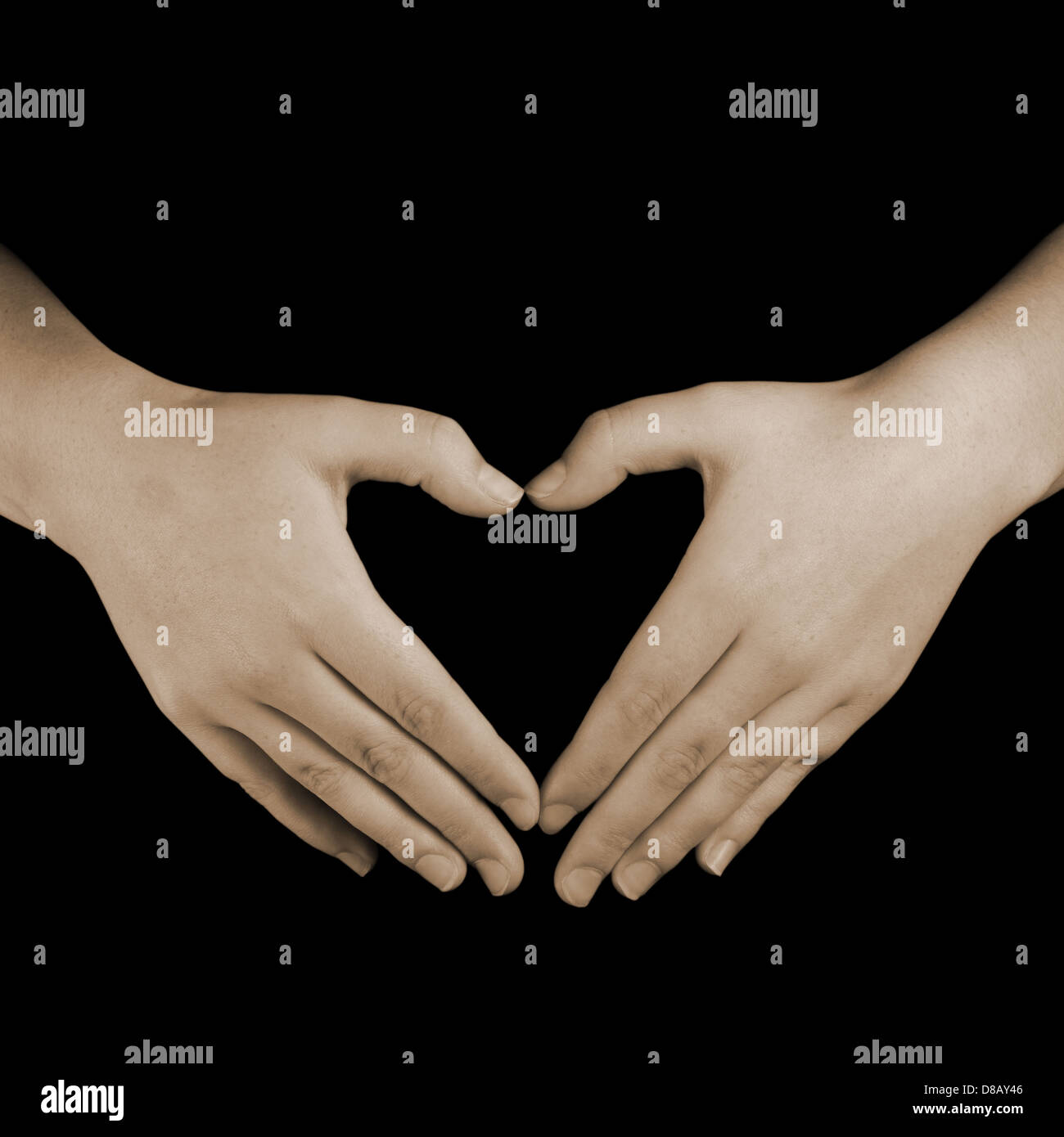 love heart hands, sepia toned on a black background Stock Photo - Alamy