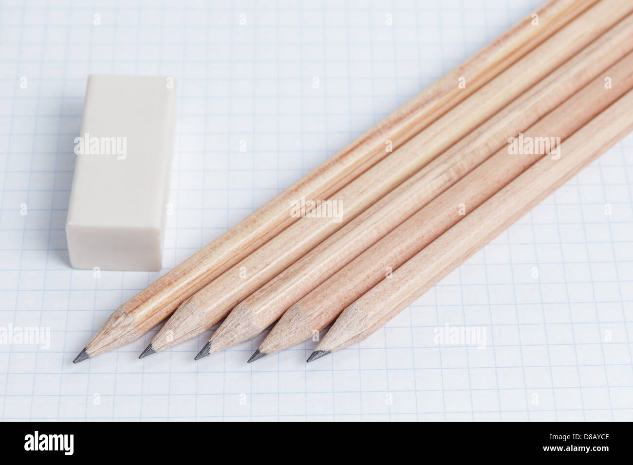 pencils and eraser on notebook page, school or business background ...