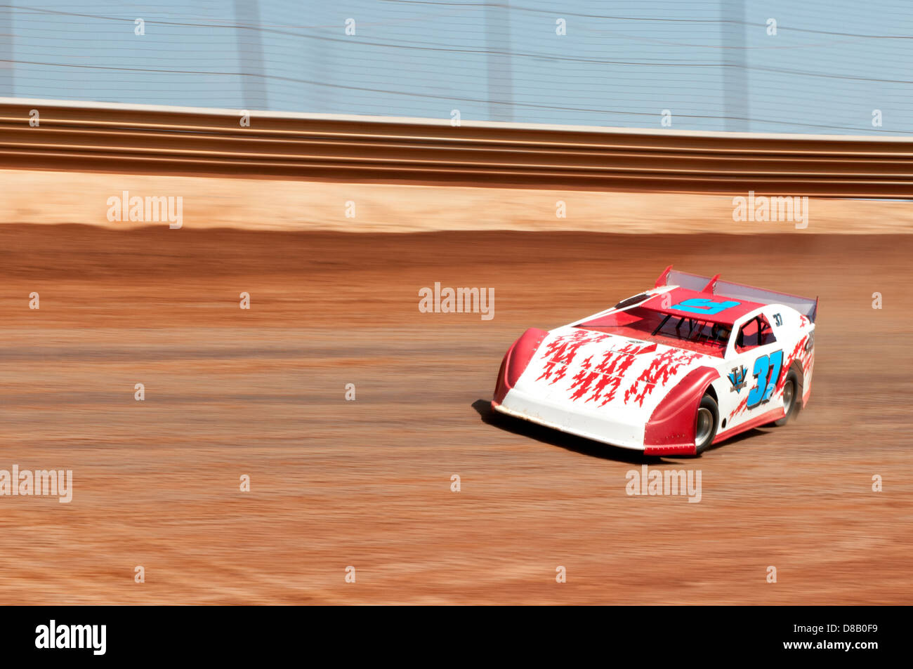 A race car speeds on a dirt track Stock Photo - Alamy