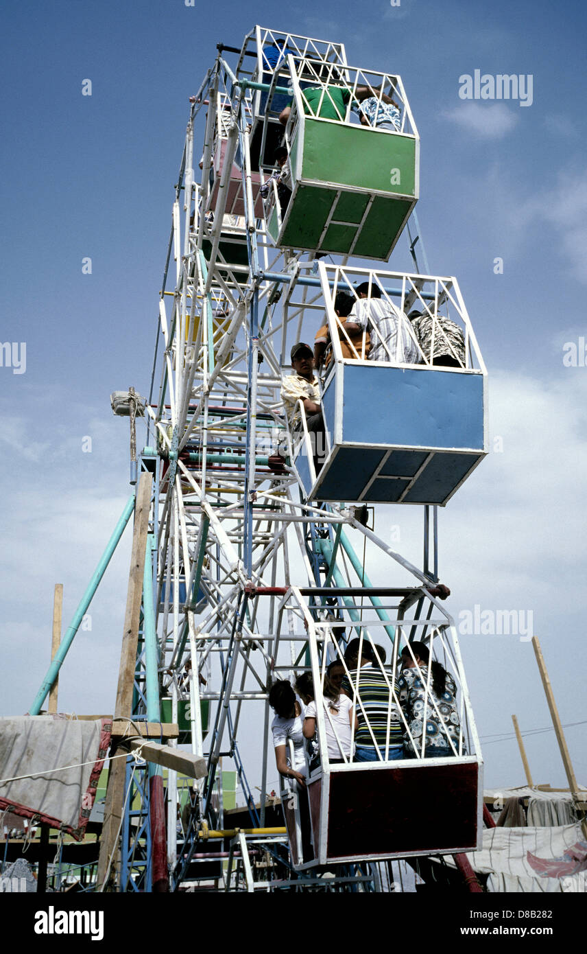 Coptic teenagers enjoy a ride on ferris wheel at Deir el-Adhra near ...