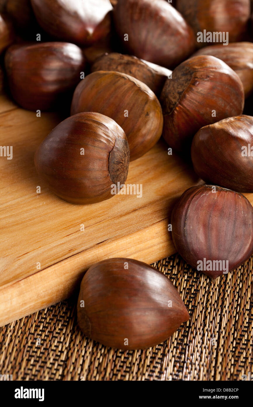 Raw Organic Brown Chestnuts against a background Stock Photo - Alamy