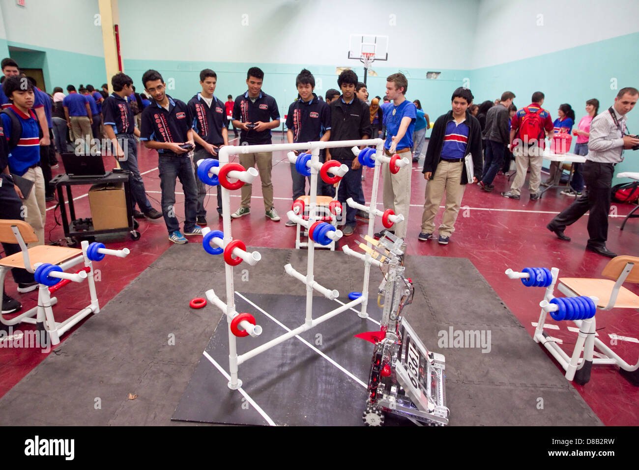 Multi-ethnic group of high school robotics club students give a ...