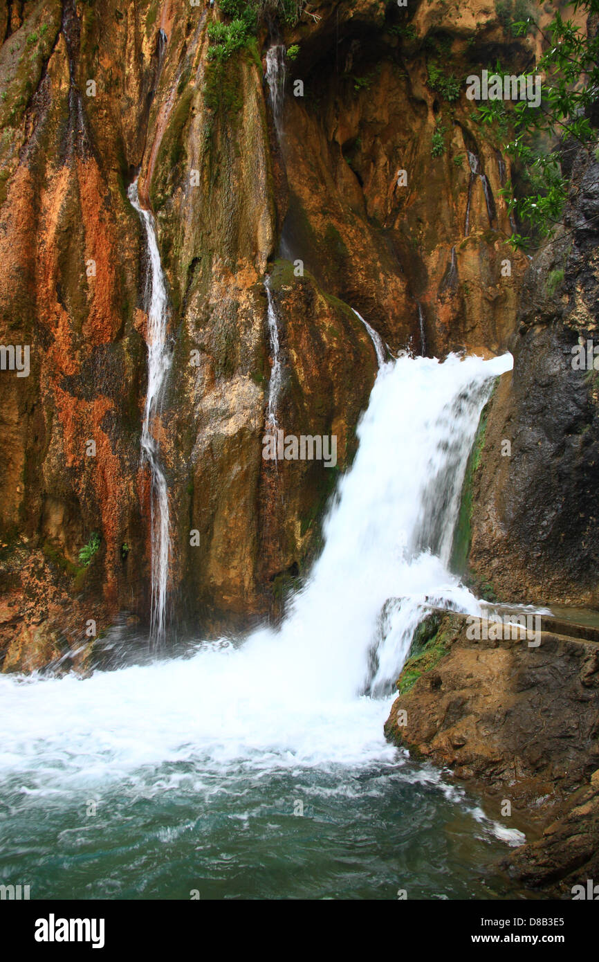 water falling to river between huge rocks Stock Photo - Alamy
