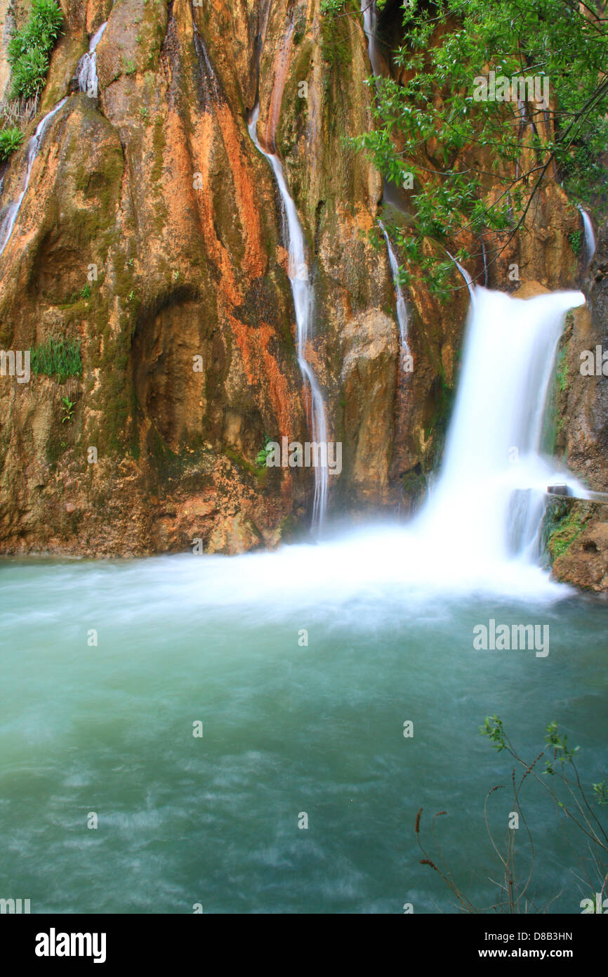 water falling to river between huge rocks Stock Photo - Alamy
