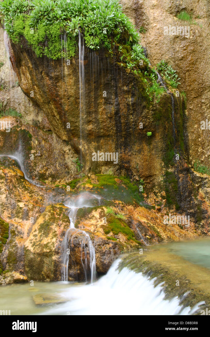water falling to river between huge rocks Stock Photo - Alamy