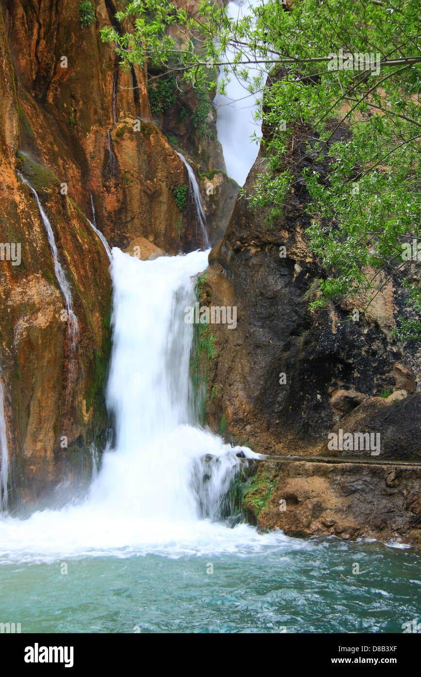 water falling to river between huge rocks Stock Photo - Alamy