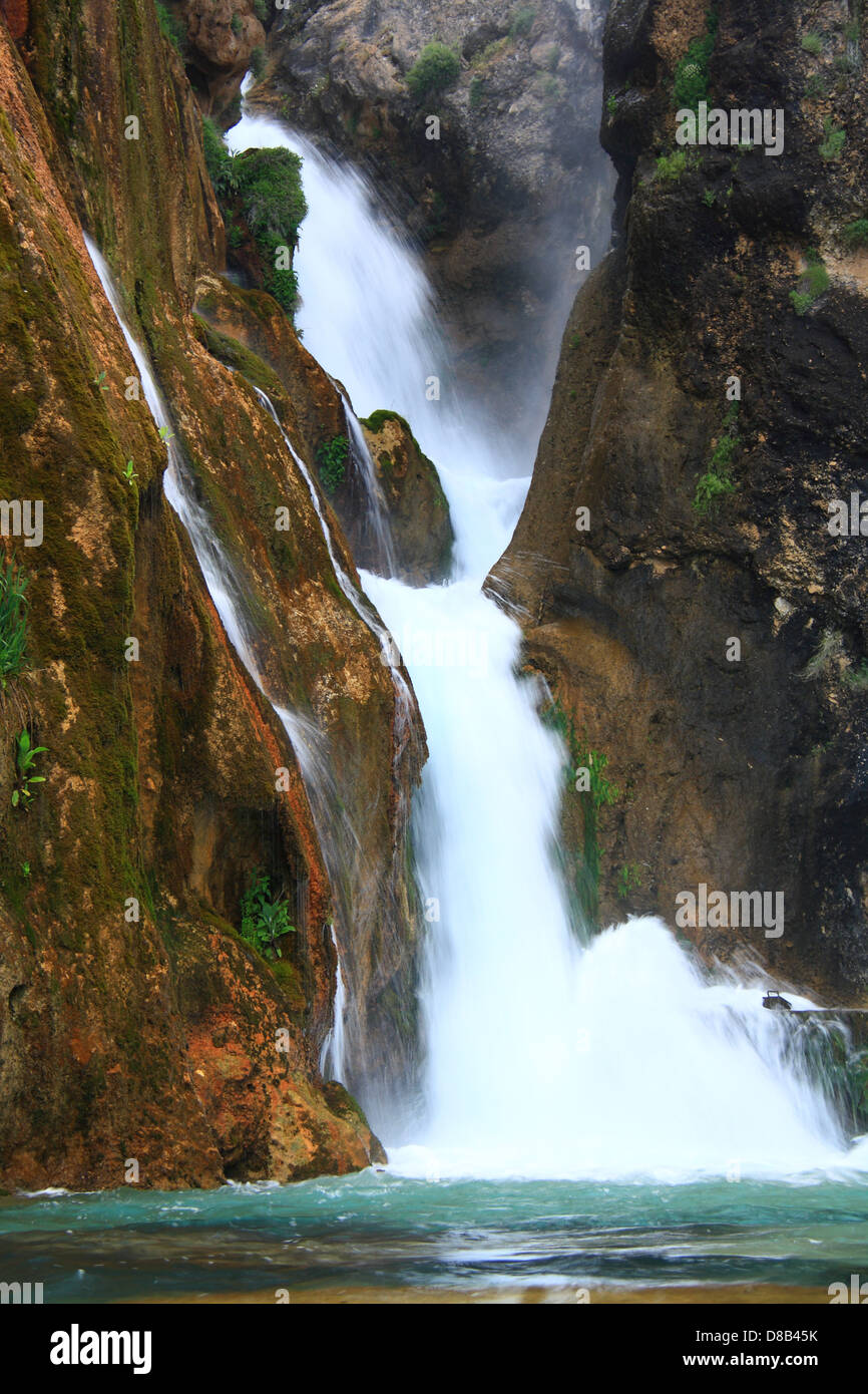 water falling to river between huge rocks Stock Photo - Alamy