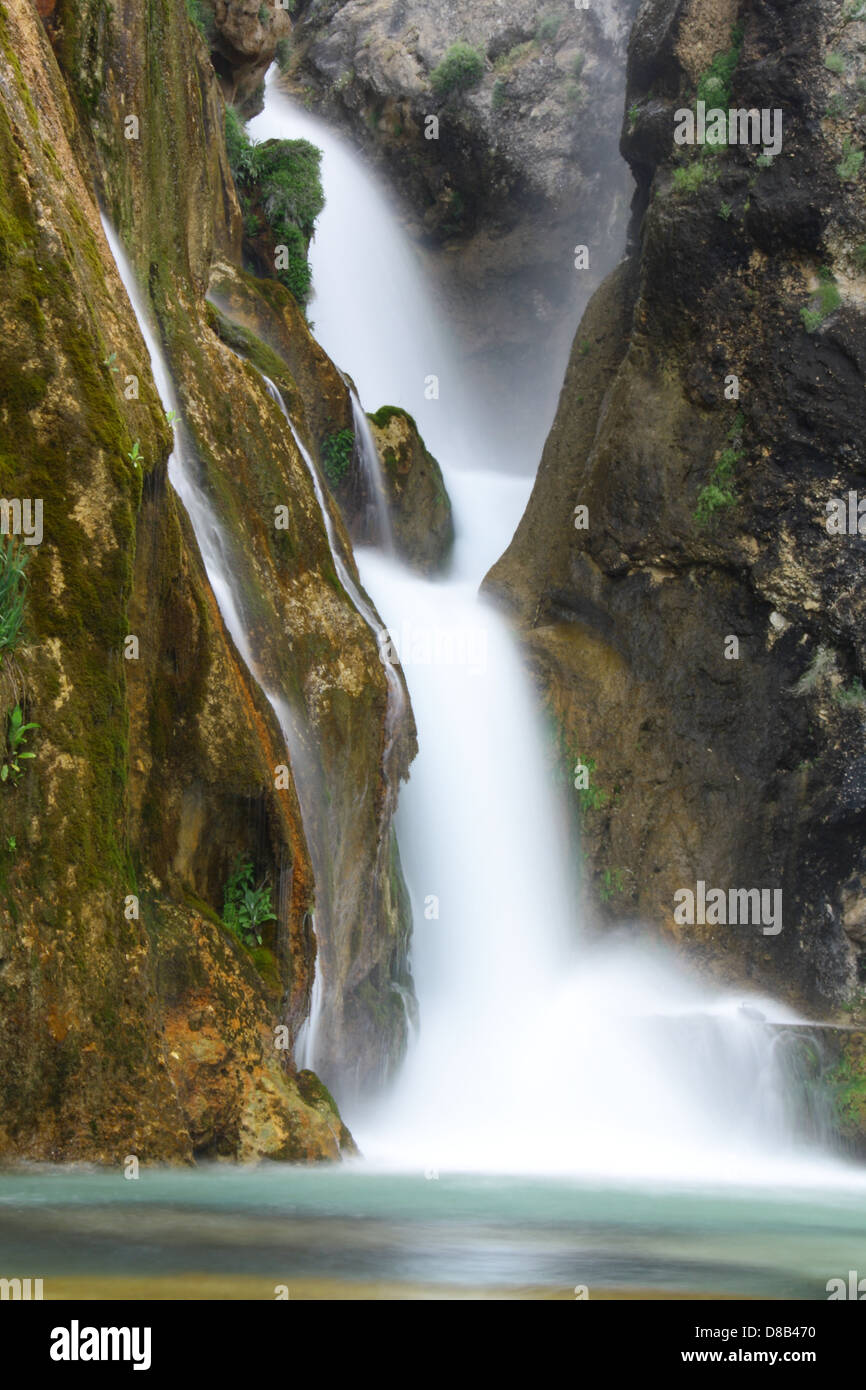 water falling to river between huge rocks Stock Photo - Alamy