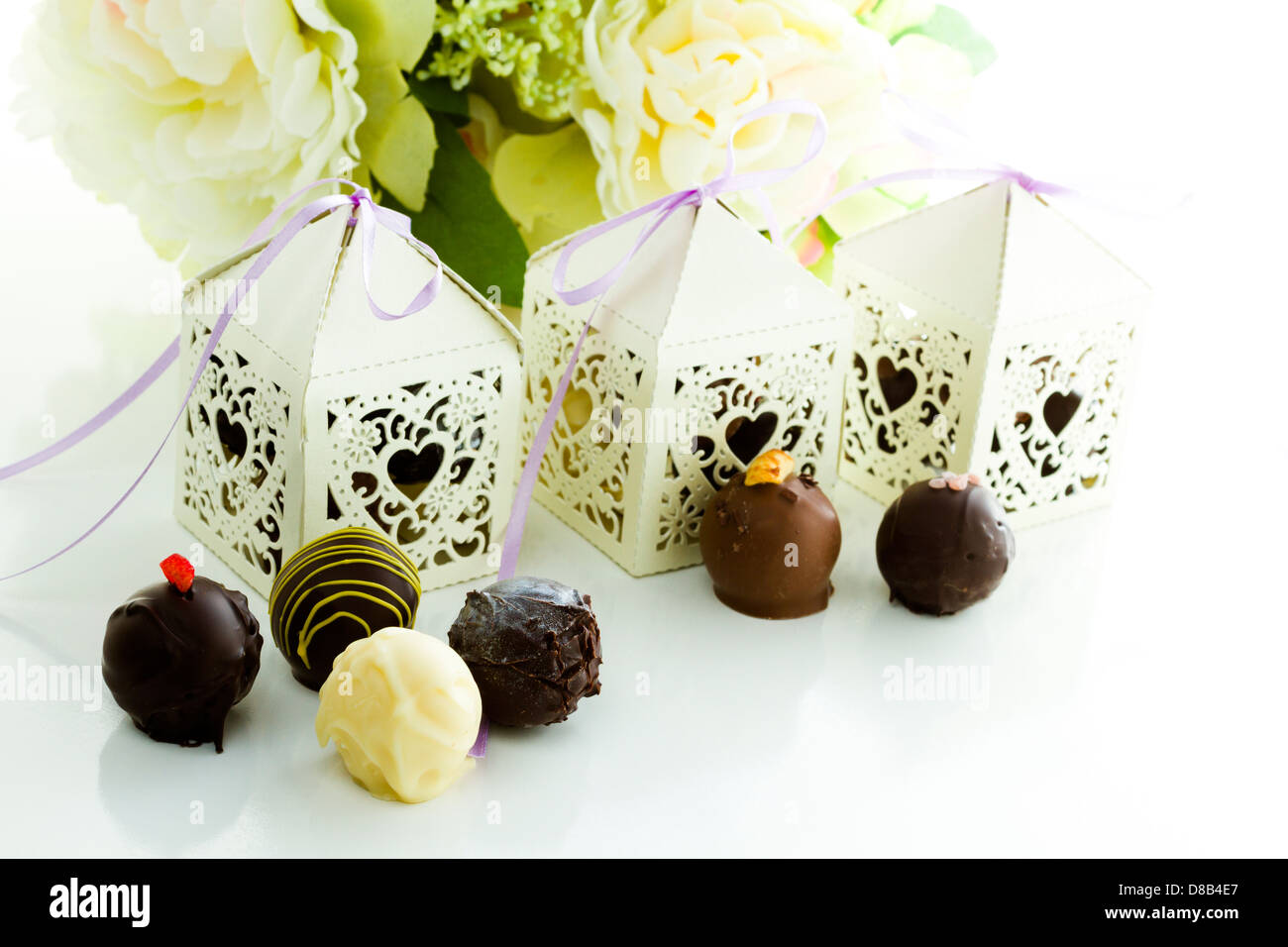 Square white decorative lace heart favor boxes filled with gourmet ...