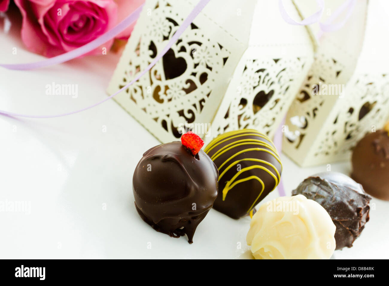 Square white decorative lace heart favor boxes filled with gourmet ...