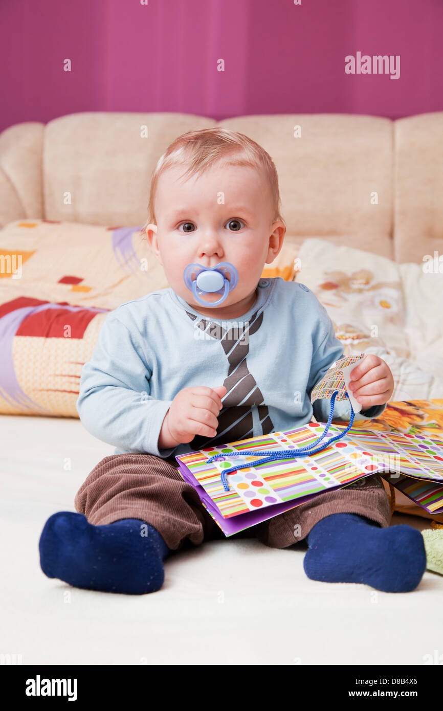Young baby boy with a dummy in his mouth looking at the camera Stock ...
