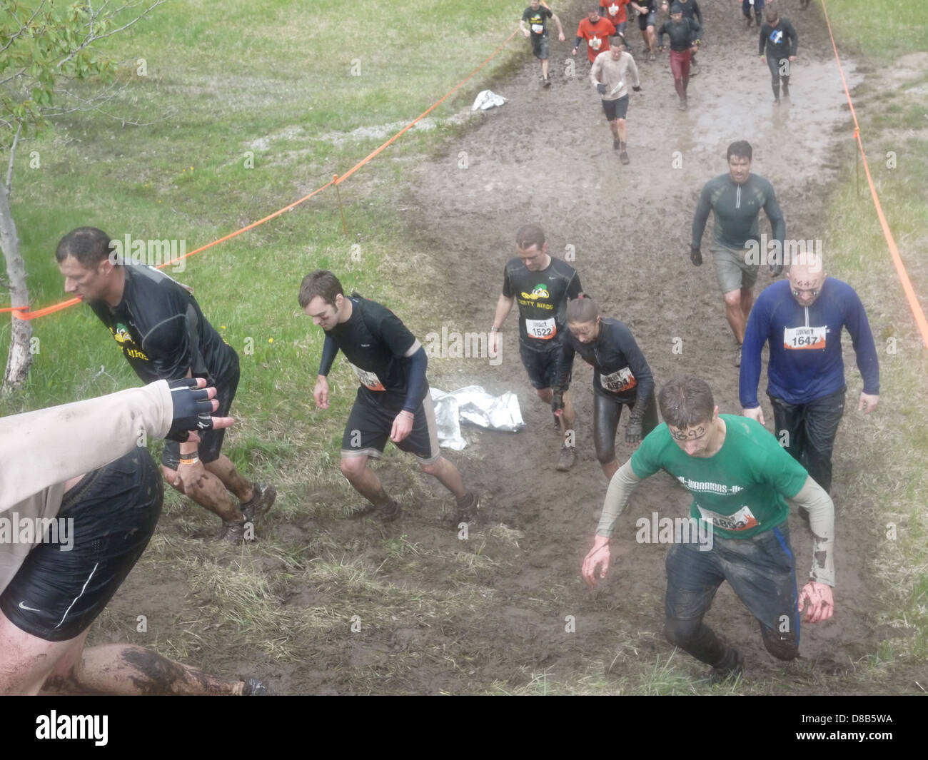 tough mudder people walking on mud Stock Photo - Alamy