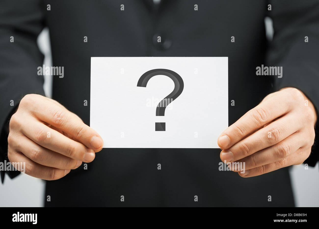 man in suit holding card with question mark Stock Photo - Alamy