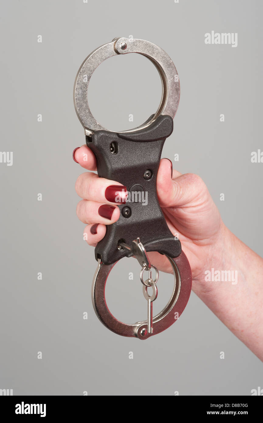 Police issue handcuffs with key in lock Stock Photo - Alamy