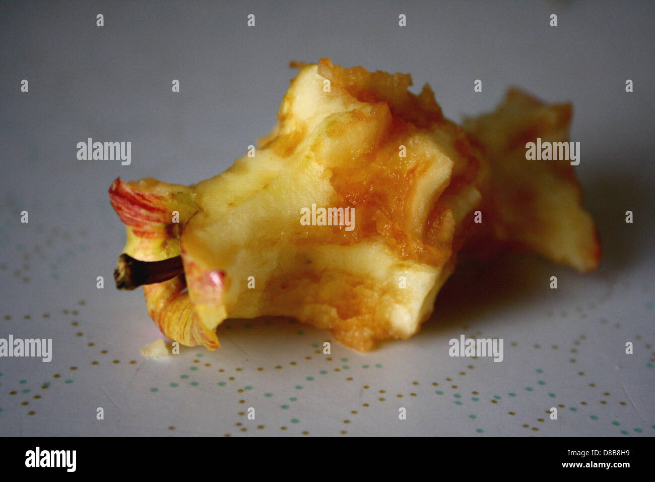 This image features an apple core, showing the remnants of the fruit ...