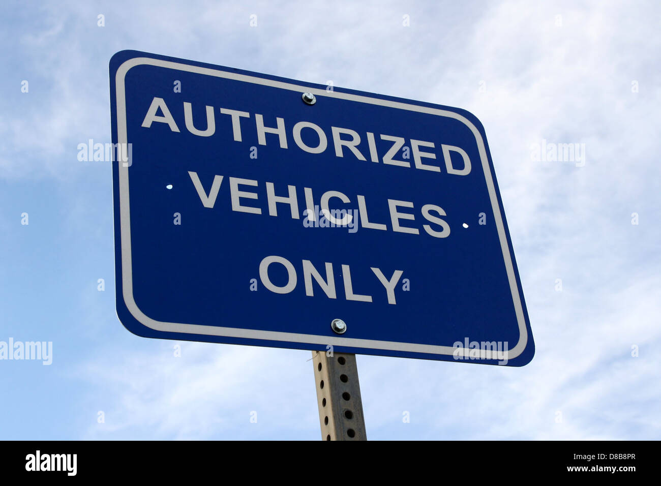 This image features a sign indicating 'Authorized Vehicles Only ...