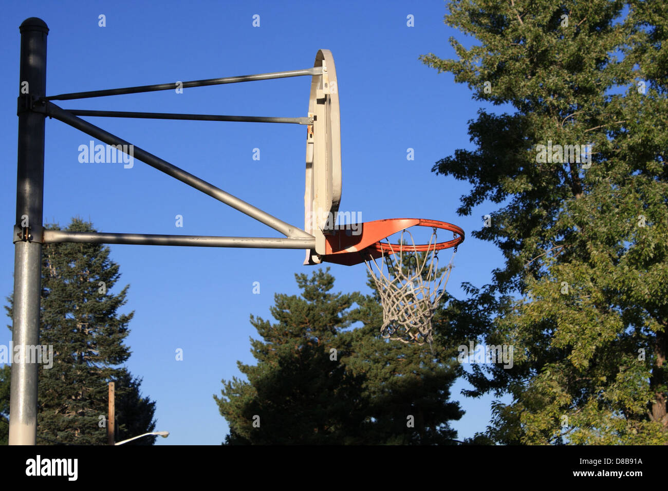 A side view of a basketball hoop, showcasing the rim, net, and ...