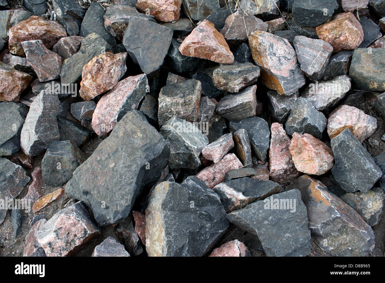 This close-up image features large black and red rocks with distinctive ...