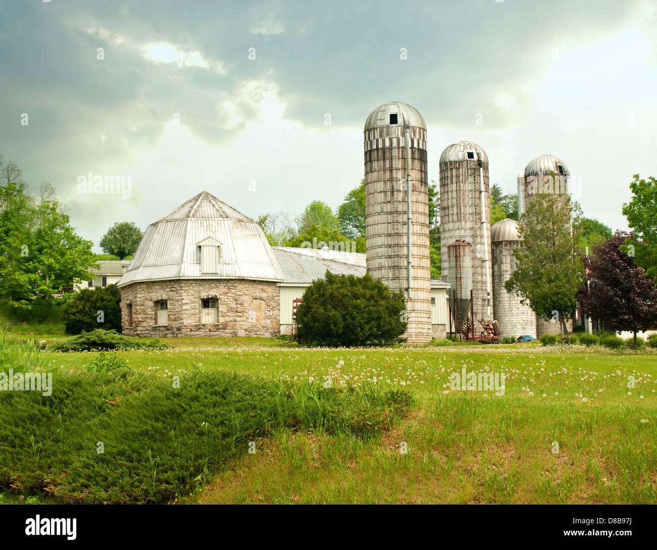 farm with stone barn and silos on a overcast spring day Stock Photo - Alamy