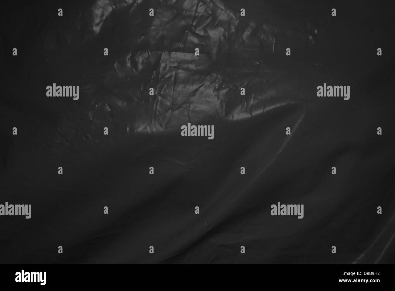 A close-up shot of black plastic with a smooth, glossy texture. The ...