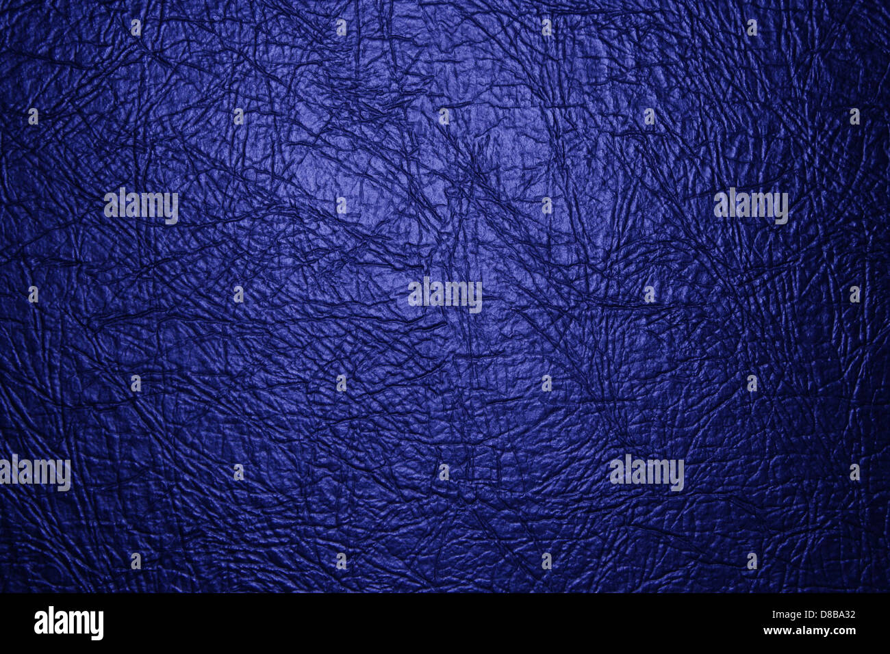 A close-up view of blue leather, highlighting its smooth texture and ...