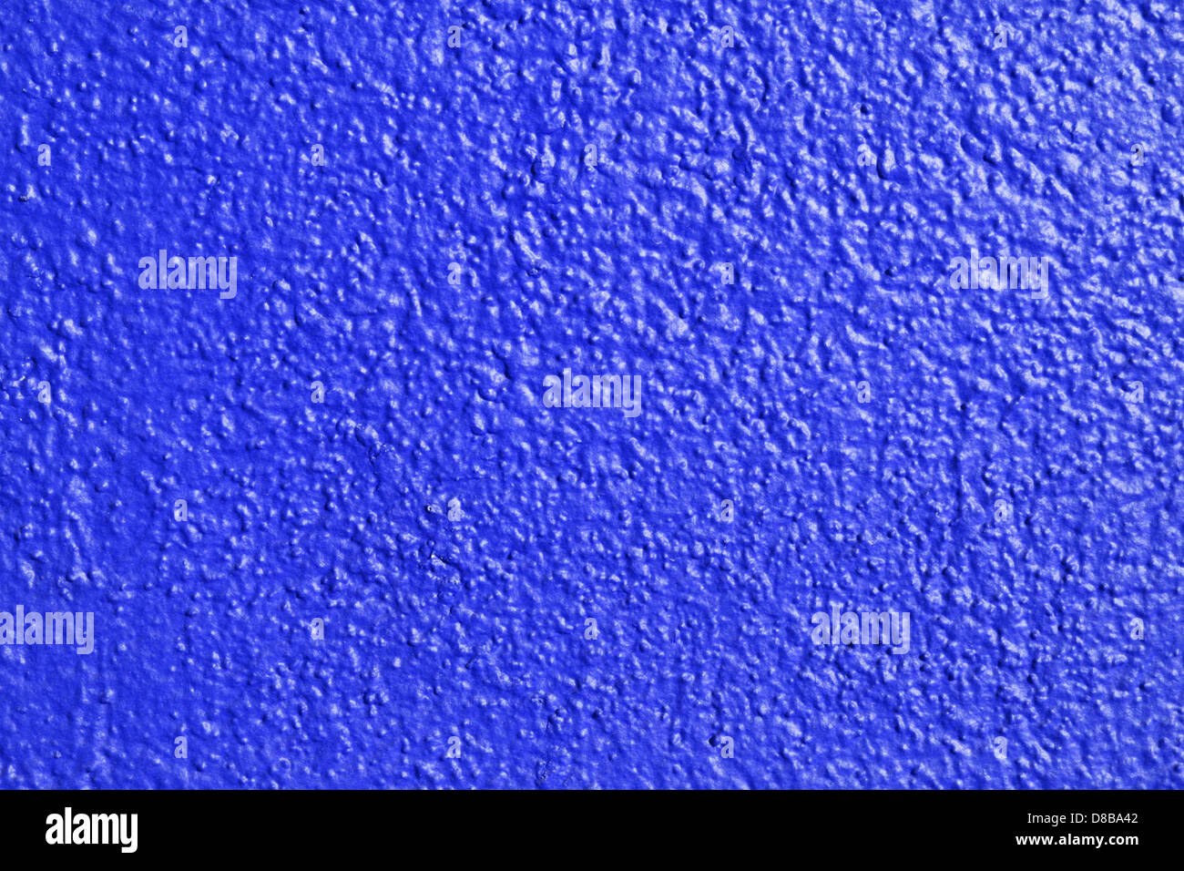 A close-up image of a blue painted wall, showcasing the texture and ...