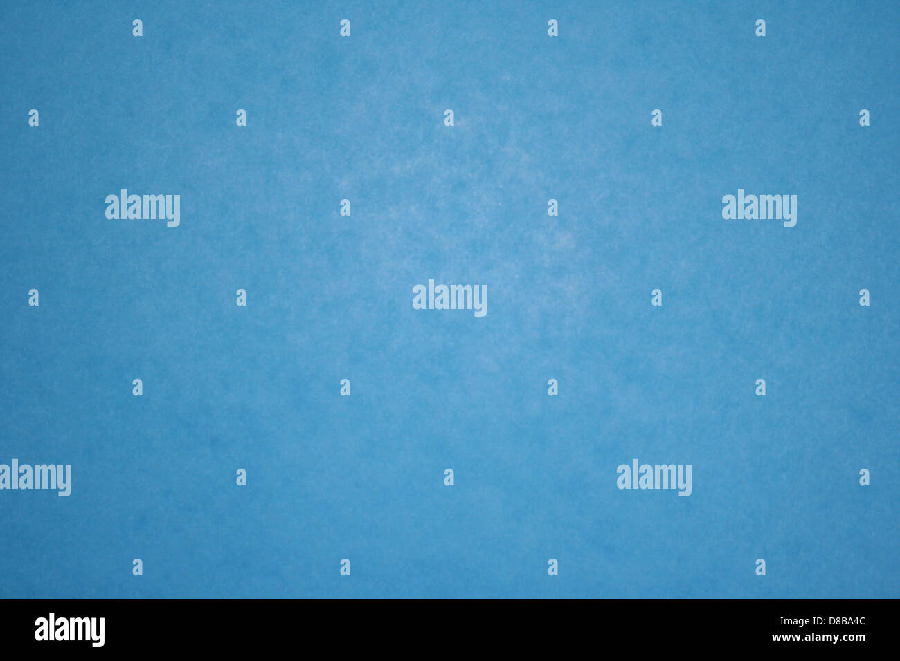 A close-up of blue paper cardstock, showing its smooth texture and ...