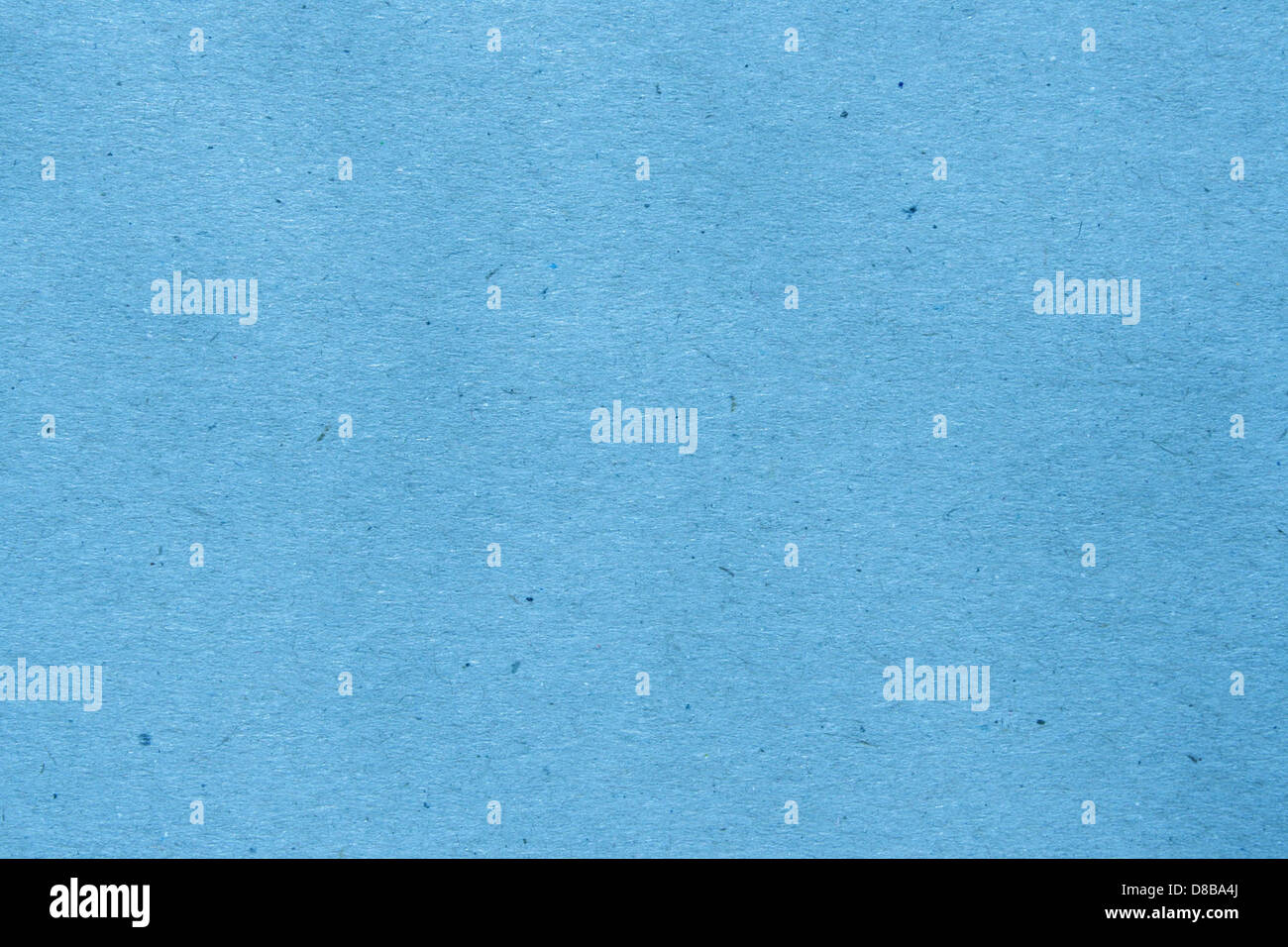 A close-up of blue paper texture featuring small flecks throughout the ...