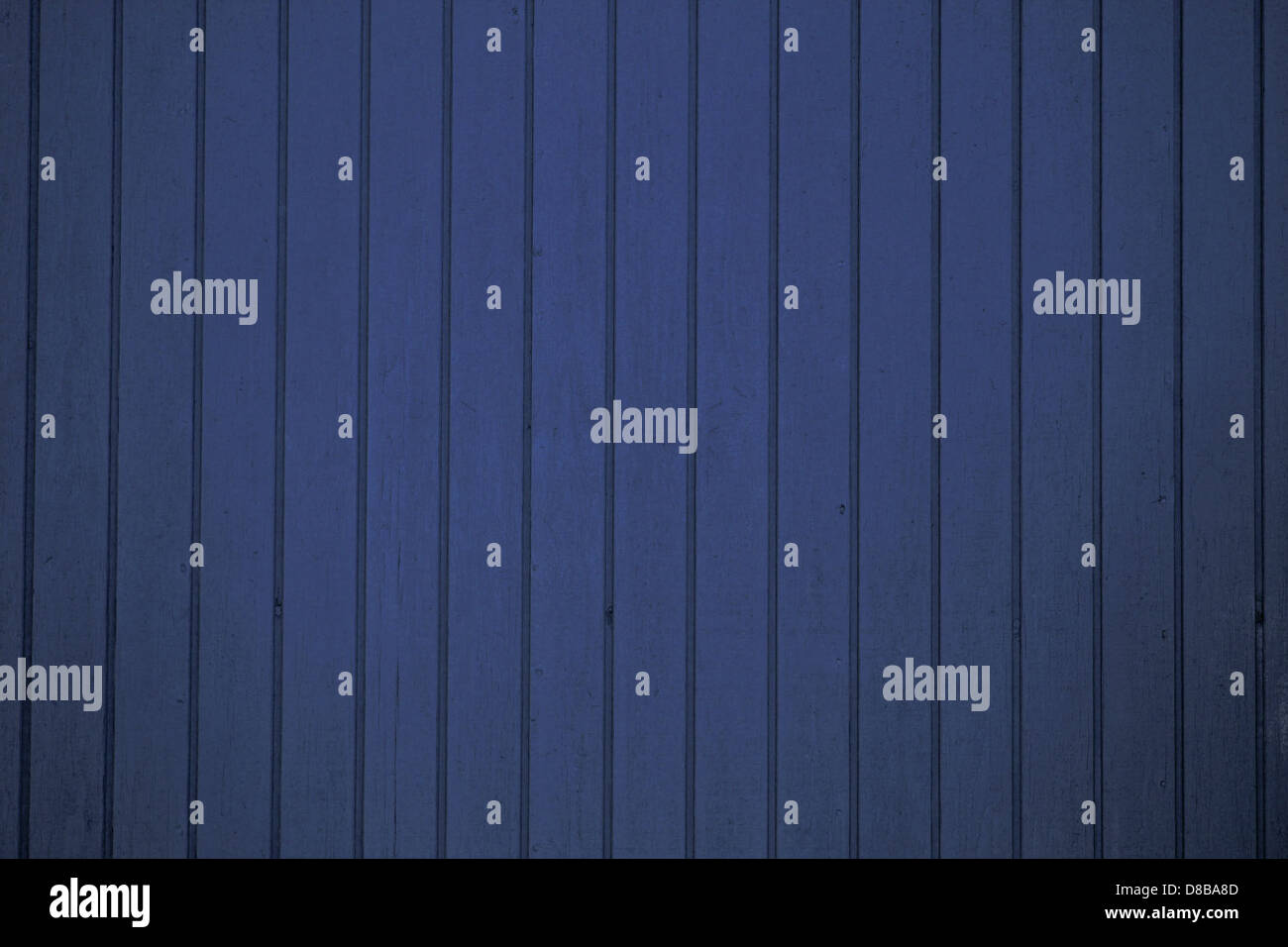 A close-up of blue vertical siding, emphasizing the texture and lines ...