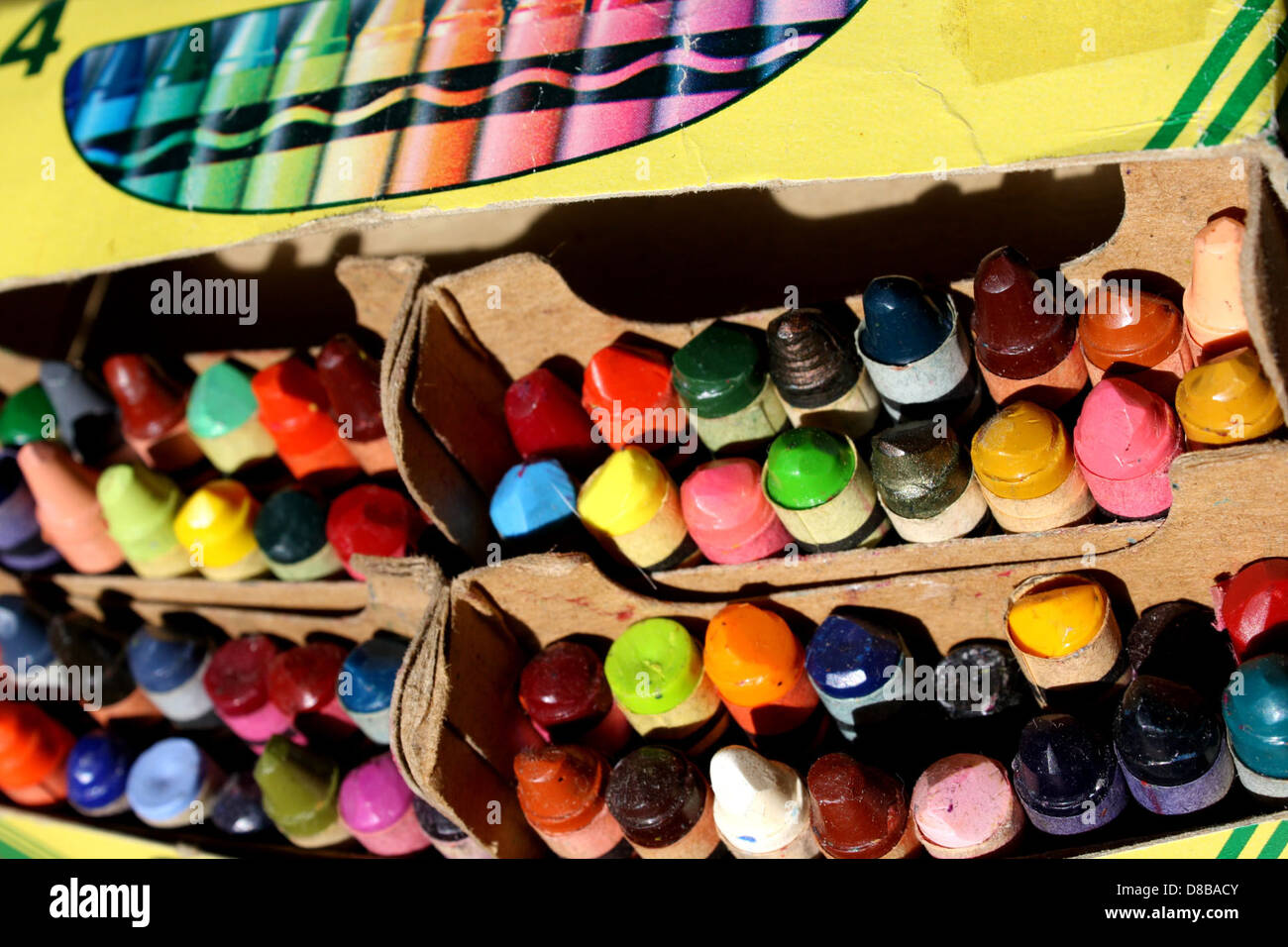 A box containing old crayons, often used by children for drawing and ...