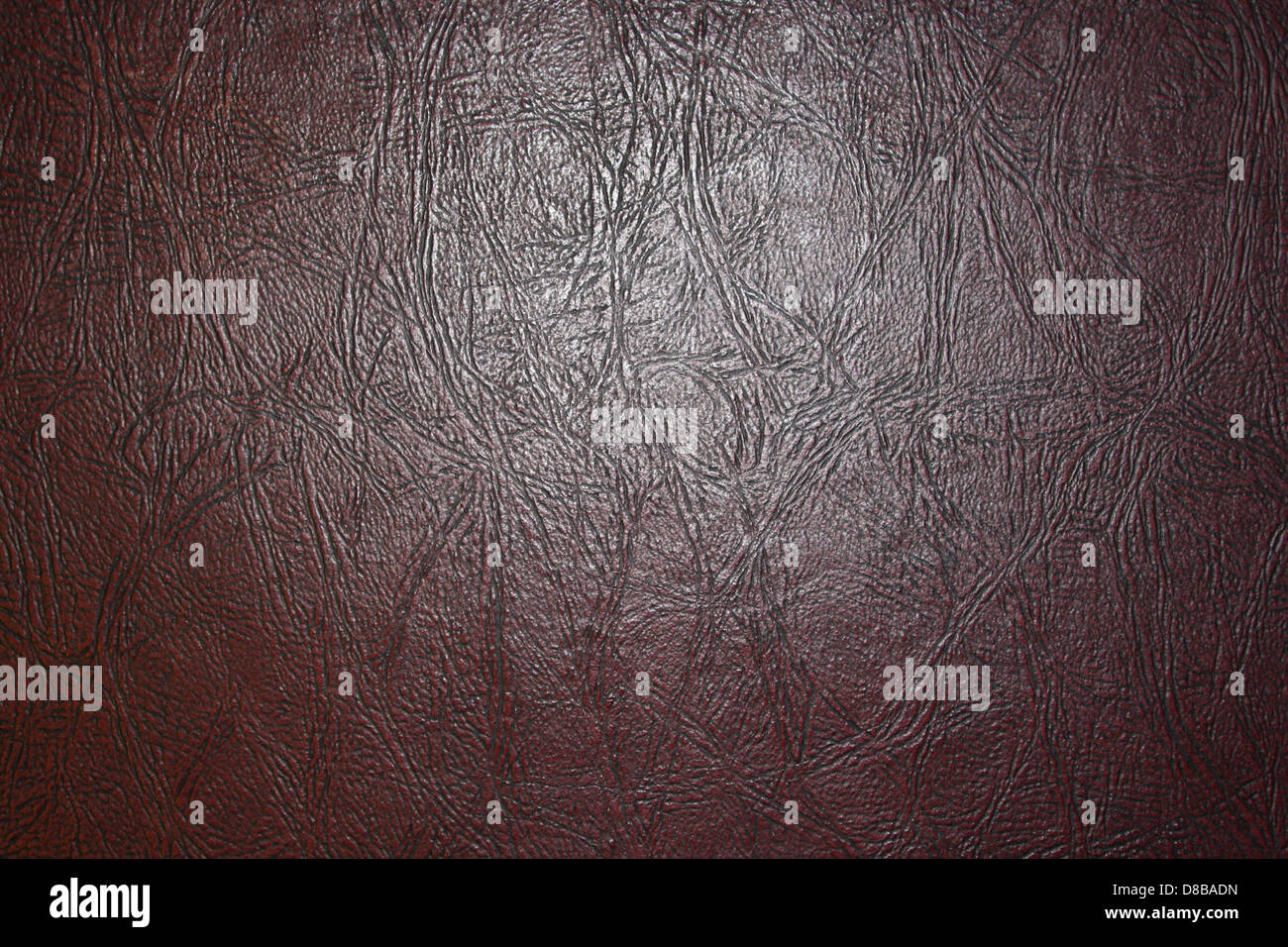 A close-up of brick red leather, highlighting its smooth texture and ...