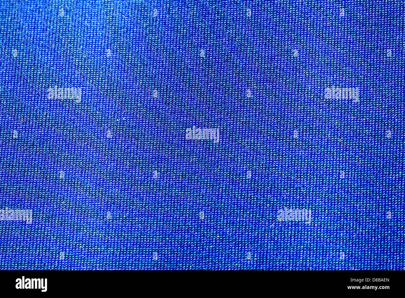 A close-up of bright blue fabric showcasing its smooth texture and ...
